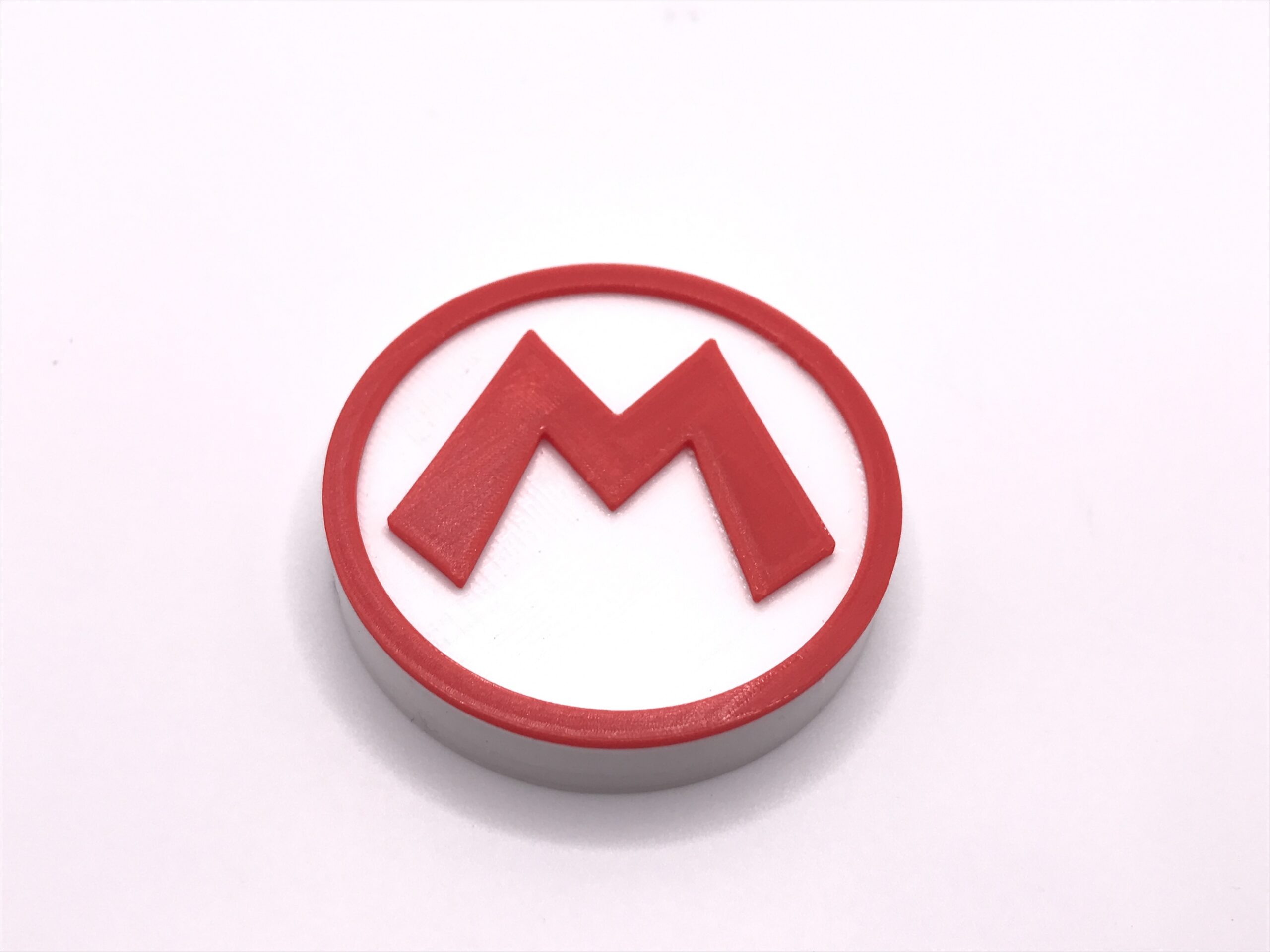The Super Mario Bros Pinball Mario Launcher Button Cover